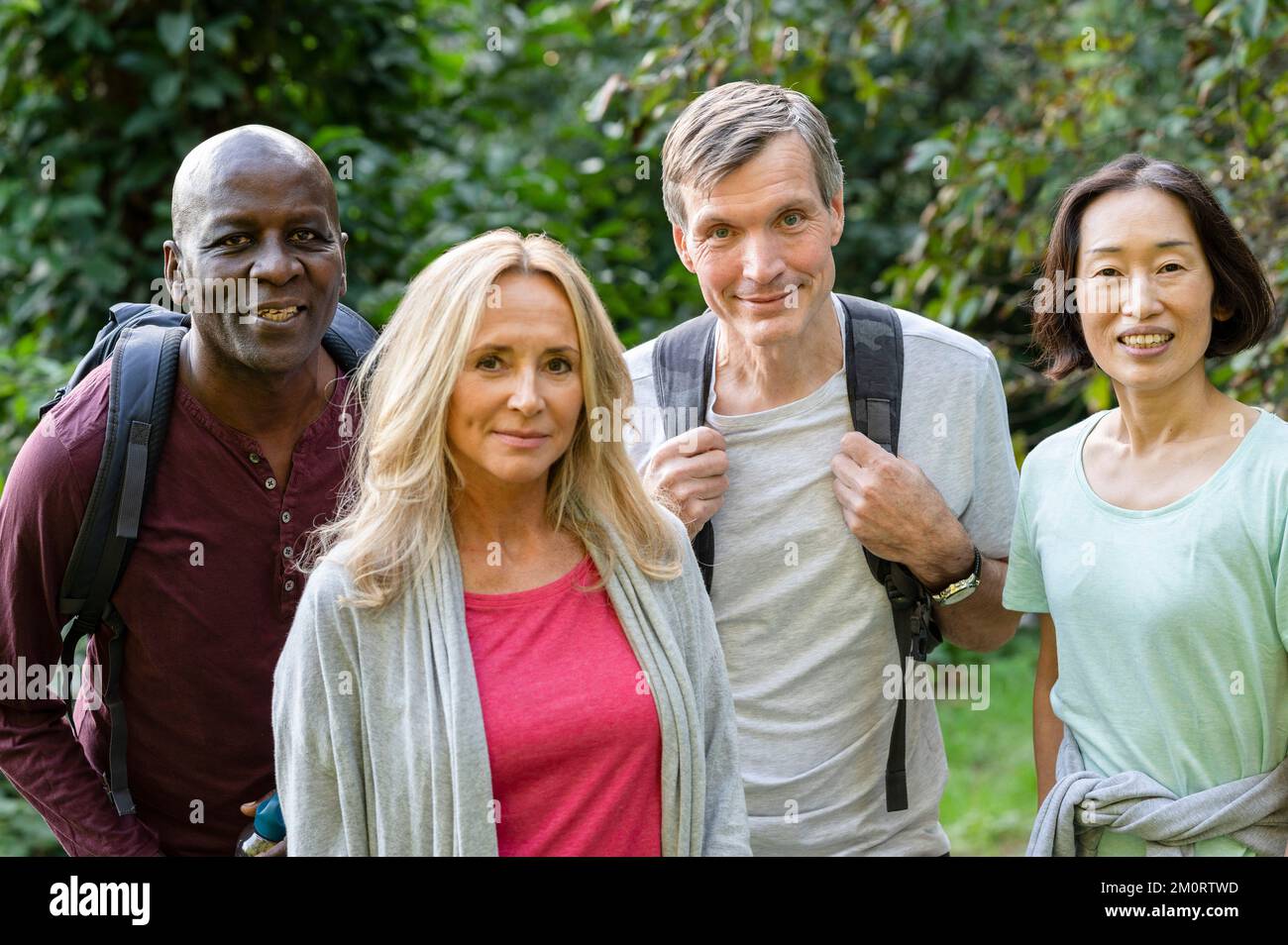 Diverse group of middle-aged friends having a good time outdoors Stock ...