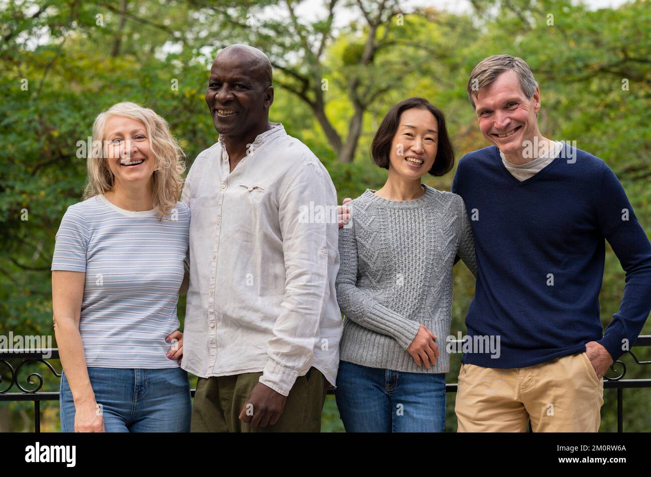 Middle-aged diverse couples hanging out in public park Stock Photo - Alamy