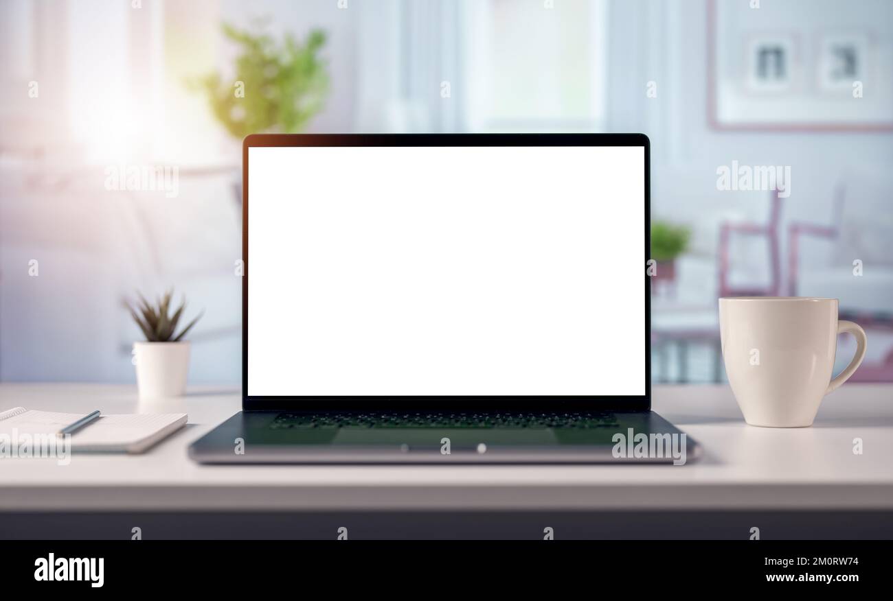 Blank screen laptop on desk Stock Photo - Alamy