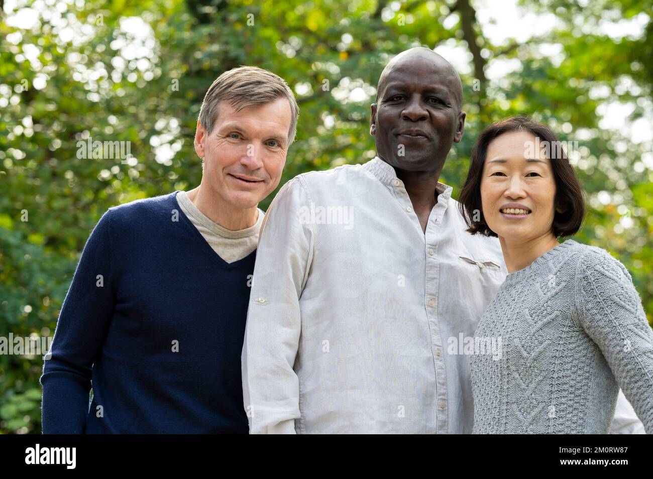 Three friends enjoying time together outdoors in public park Stock ...