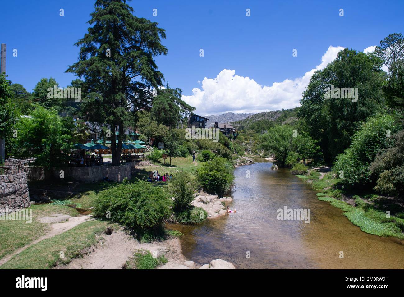A scenic view of a river flowing through the residential area with ...