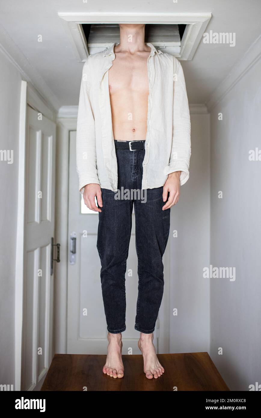 Man stuck his head in the attic Stock Photo - Alamy