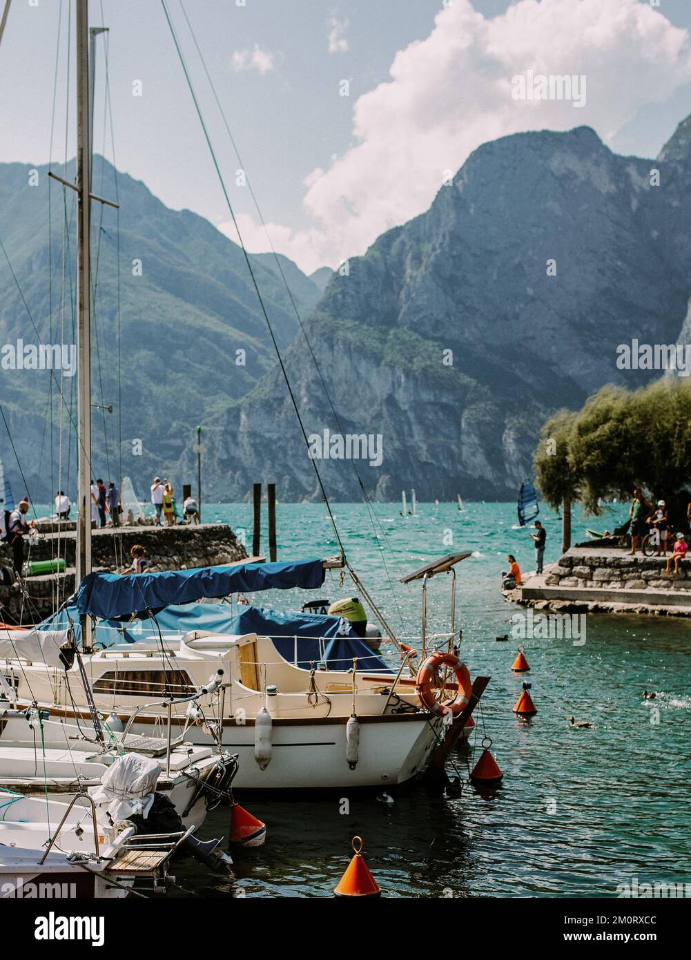 Boats on a mountain lake harbor Stock Photo - Alamy