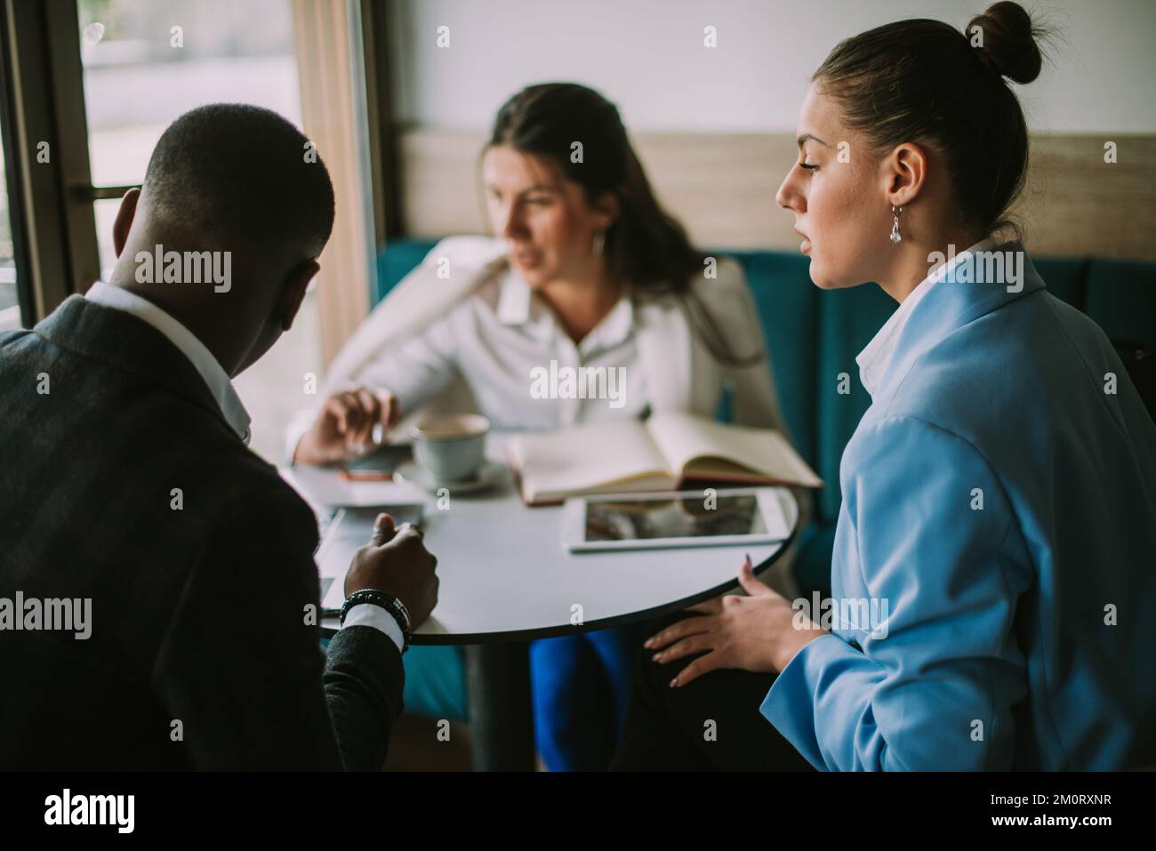 Three students conversating and discussing about their upcoming ...
