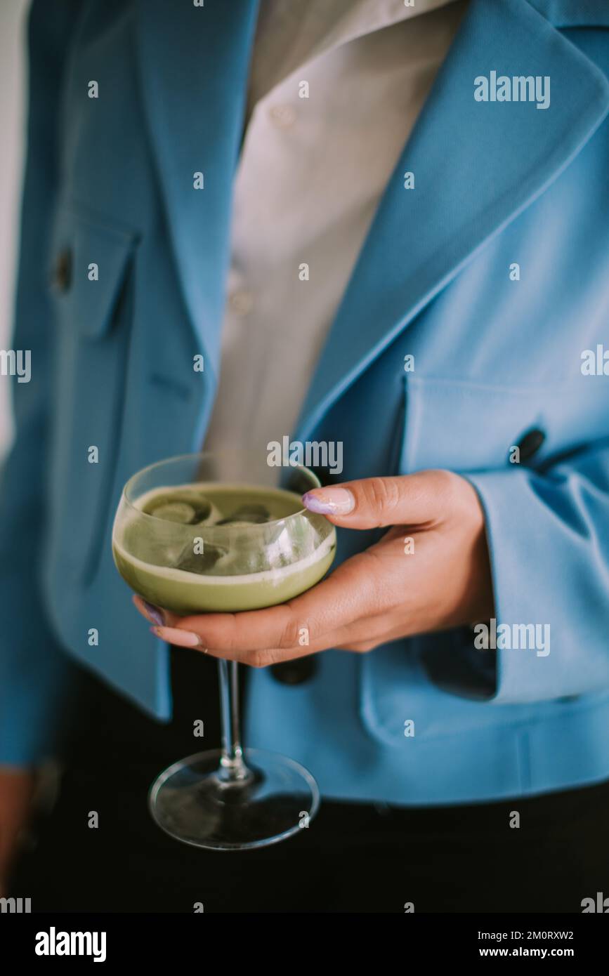 Close up of business woman in blue suit holding matcha latte Stock ...