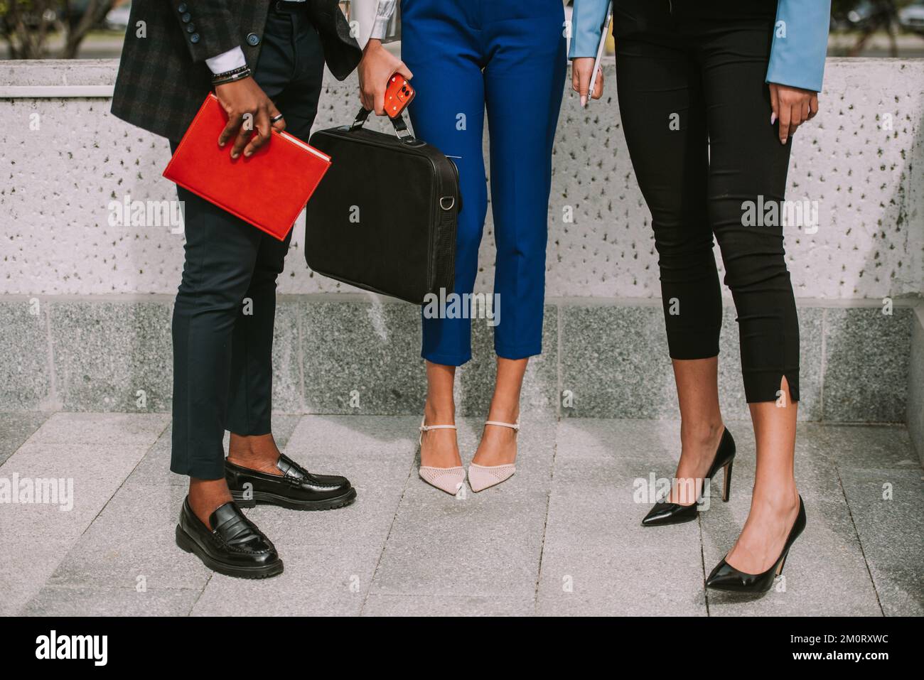 Close up of three business people with notebook,phone,tablet and ...