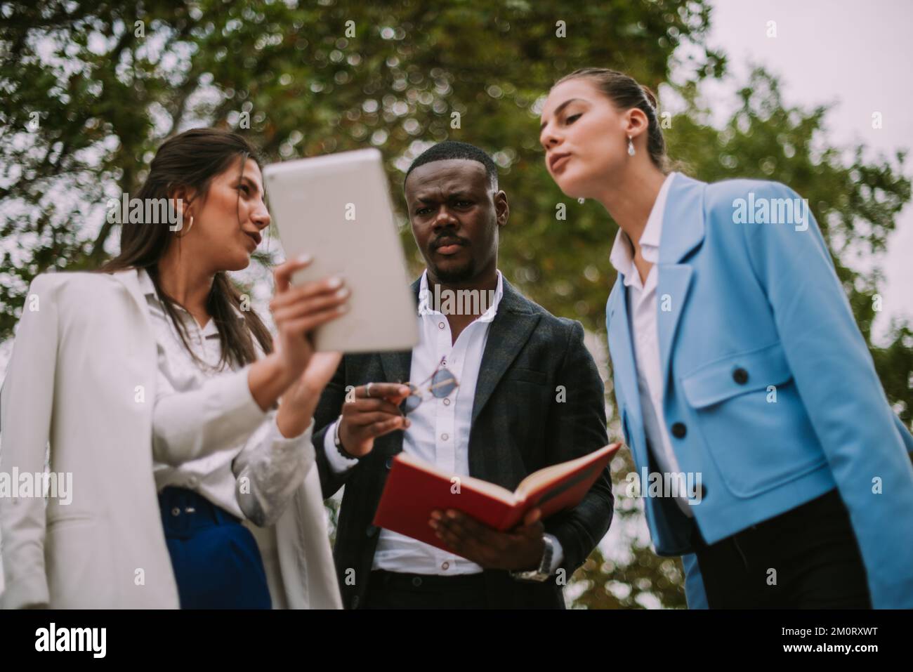 Close up of business woman showing something on the tablet to her ...