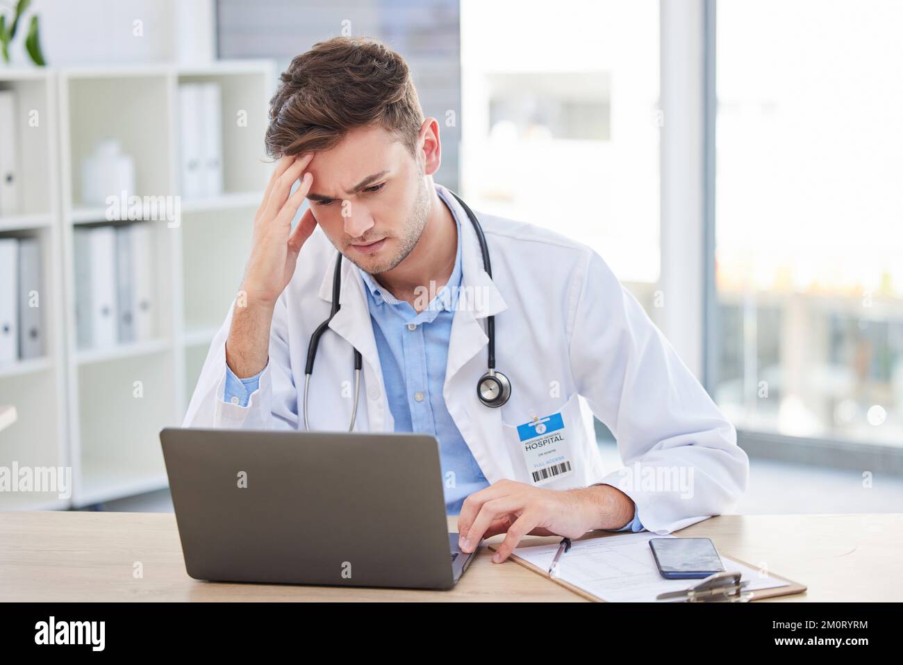 Doctor, laptop and stress headache about bad news or diagnosis for ...