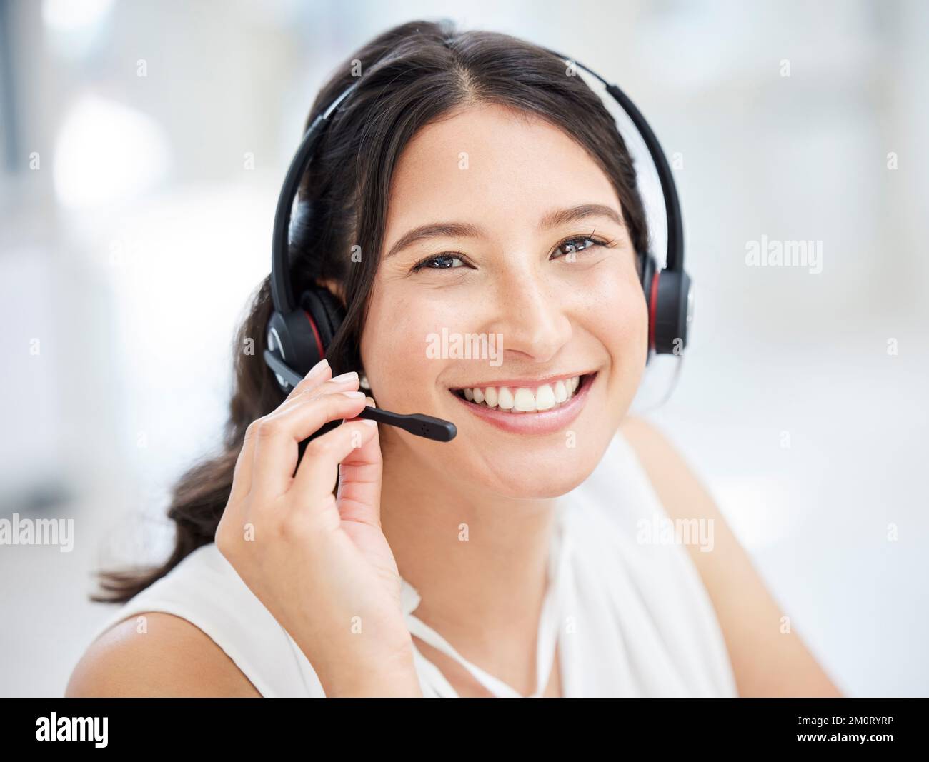 Of course I can help. Portrait of a young call centre agent working in ...