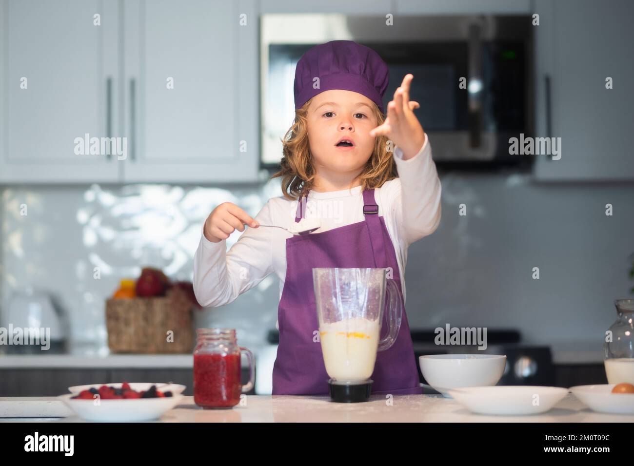 Kid cooking. Chef child cook baking on the kitchen Stock Photo - Alamy