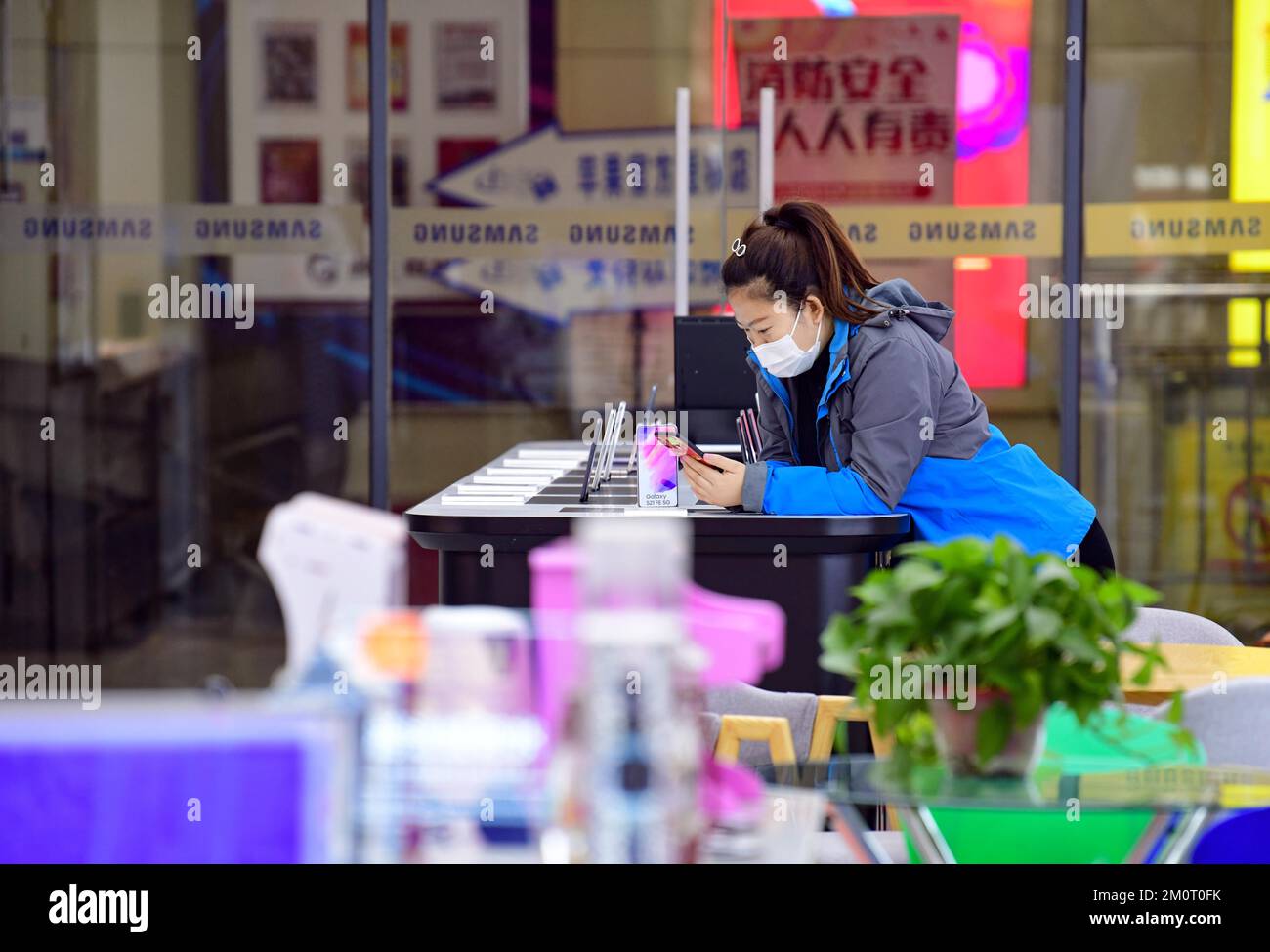 A shop assistant is working in a local digital mall in Hohhot City ...