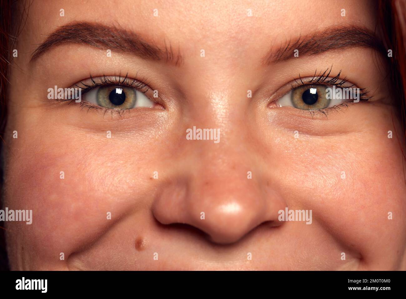 Smiling look. Close-up image of green-brown female eyes looking at ...