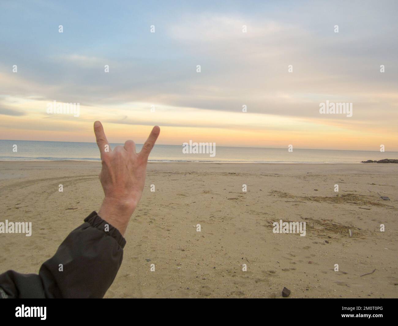 Hand symbol at the beach in New Jersey at Sunset Stock Photo - Alamy