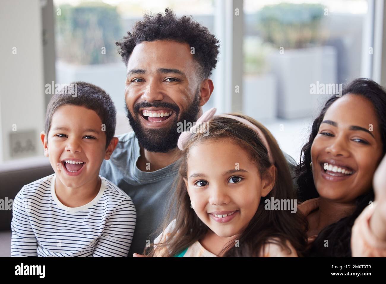 Good days start with a smile. a young family relaxing together at home ...