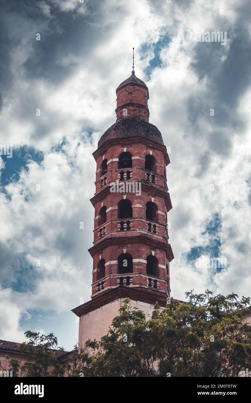 A vertical shot of Saint Sernin basilica in Toulouse with a cloudy blue ...