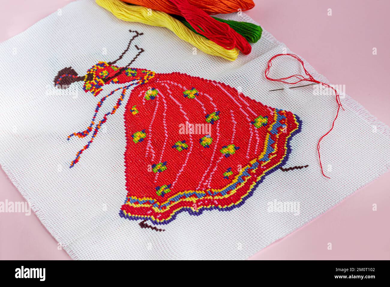 Handmade embroidery. Multicolored patterns on white fabric. Ethnic ...