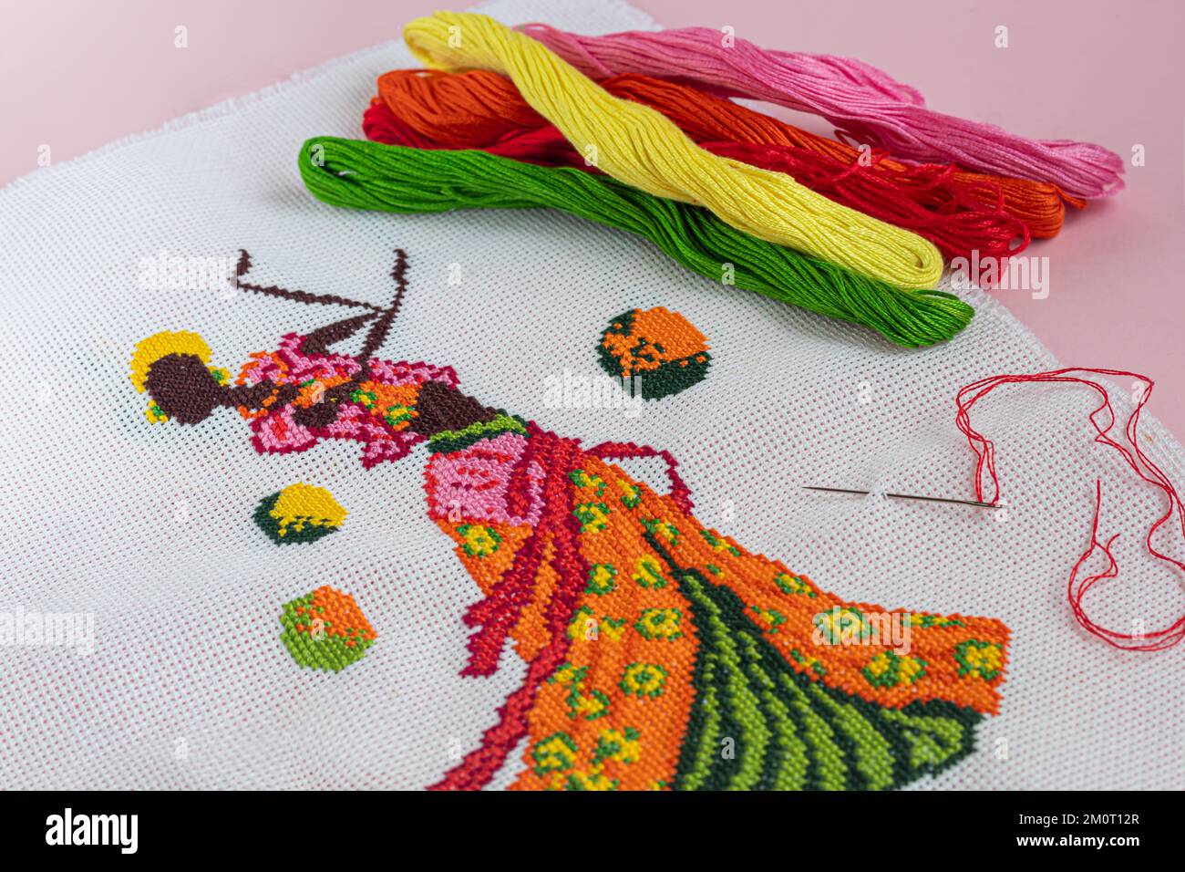 Handmade embroidery. Multicolored patterns on white fabric. Ethnic ...