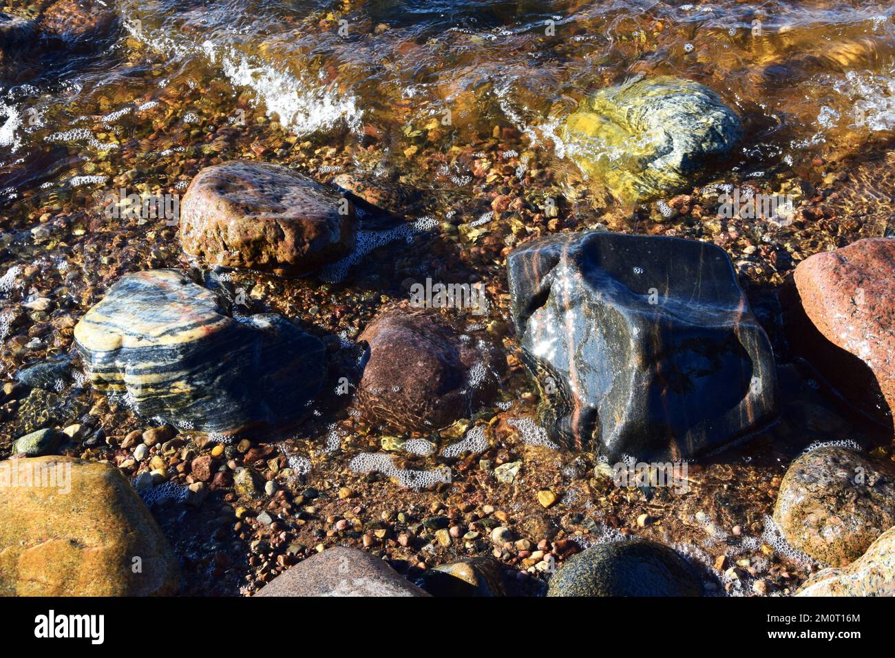 A closeup shot of wet rocks near the water Stock Photo - Alamy