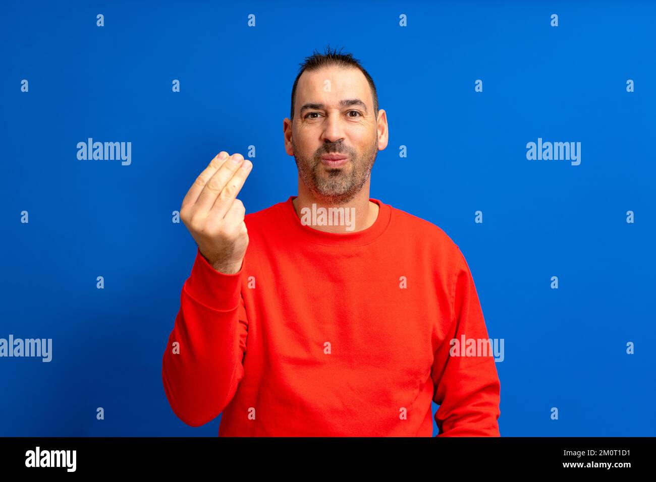 Handsome latino man with beard making a typical italian gesture ...
