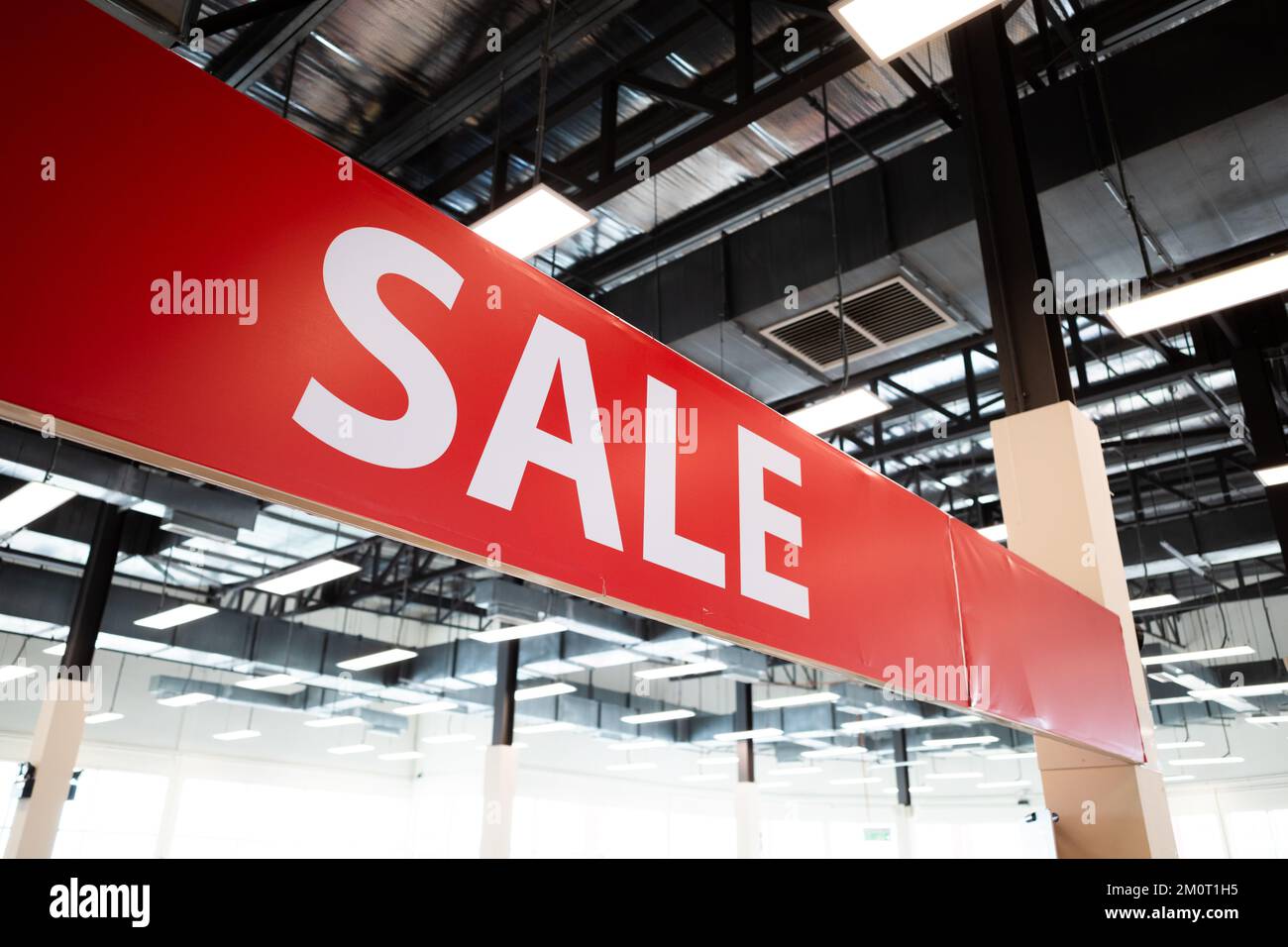 A red SALE sign hanging inside a store during the weekend Stock Photo ...