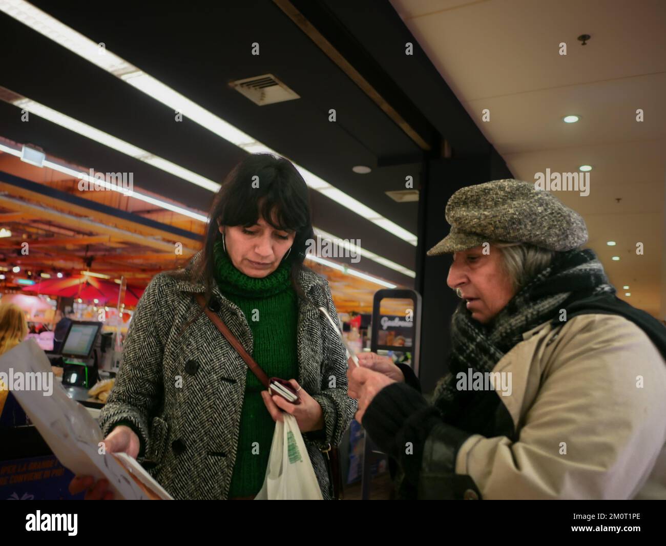 senior european lady and hispanic young adult woman controlling the ...