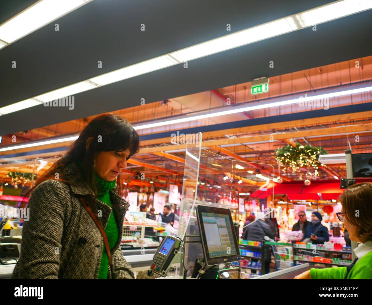 Cremona, Italy - December 2022 Latin hispanic woman at the cashier in ...