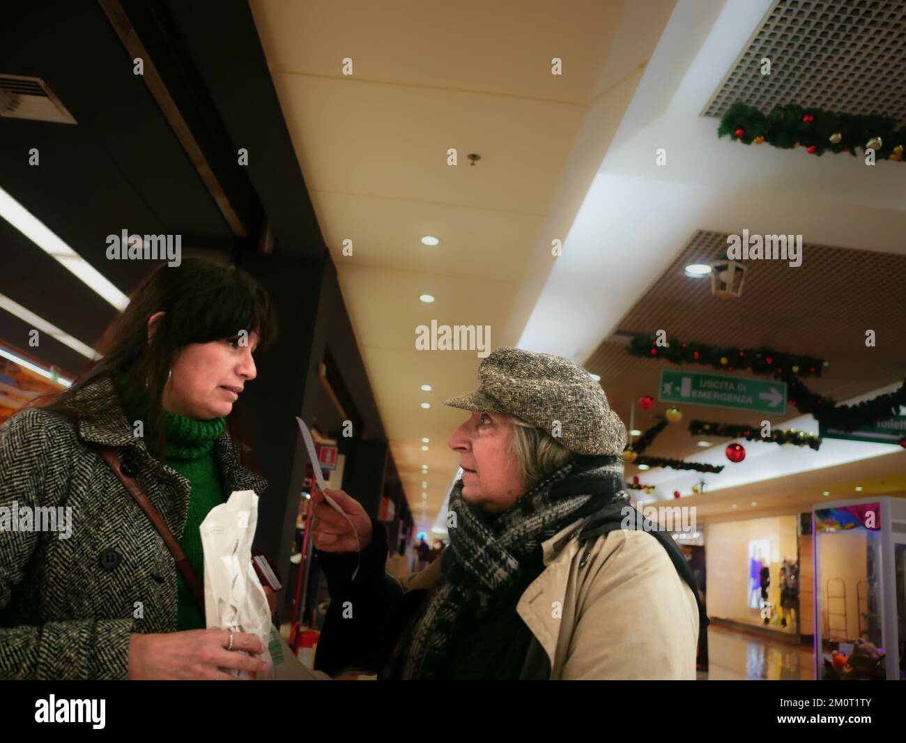 senior european lady and hispanic young adult woman controlling the ...