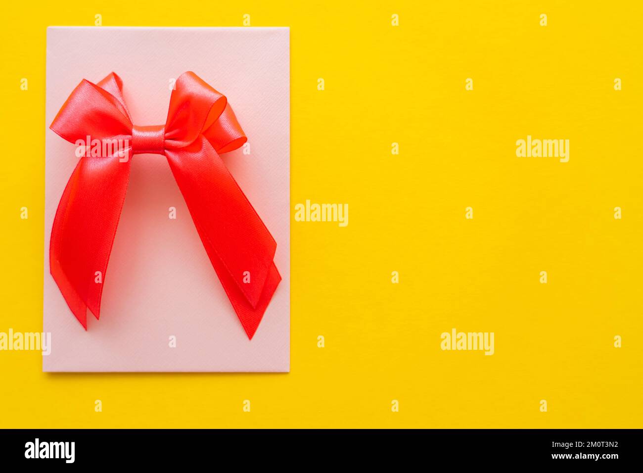 Top view of bow on greeting card on yellow background,stock image Stock ...