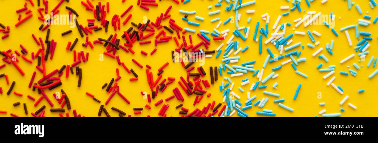 Top view of red and blue sprinkles on yellow background, banner,stock ...
