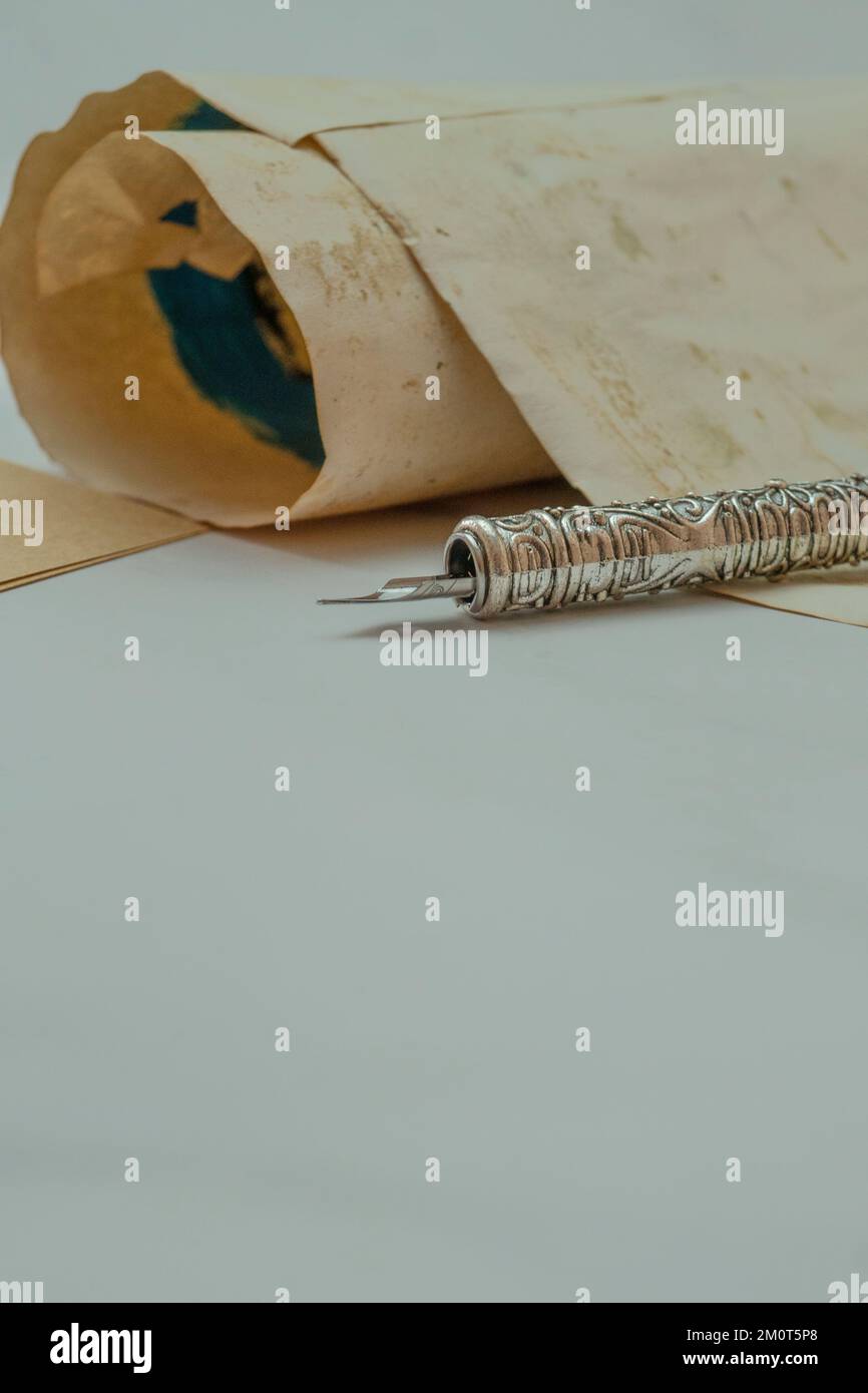 A roll of parchment paper with a vintage pen Stock Photo - Alamy