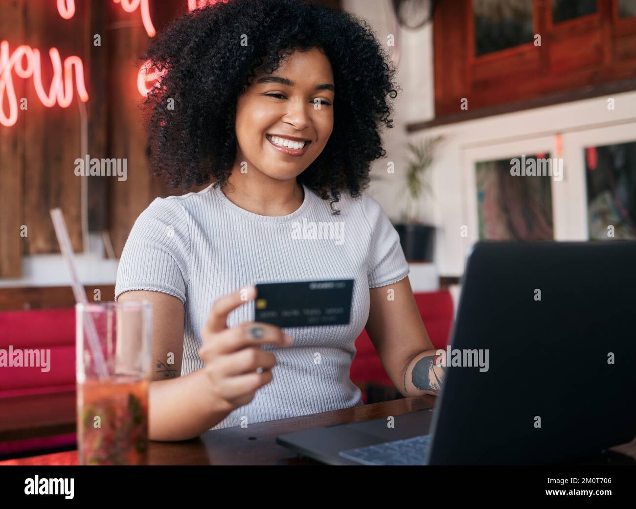 Woman, credit card and laptop in cafe, ecommerce and discount purchase ...