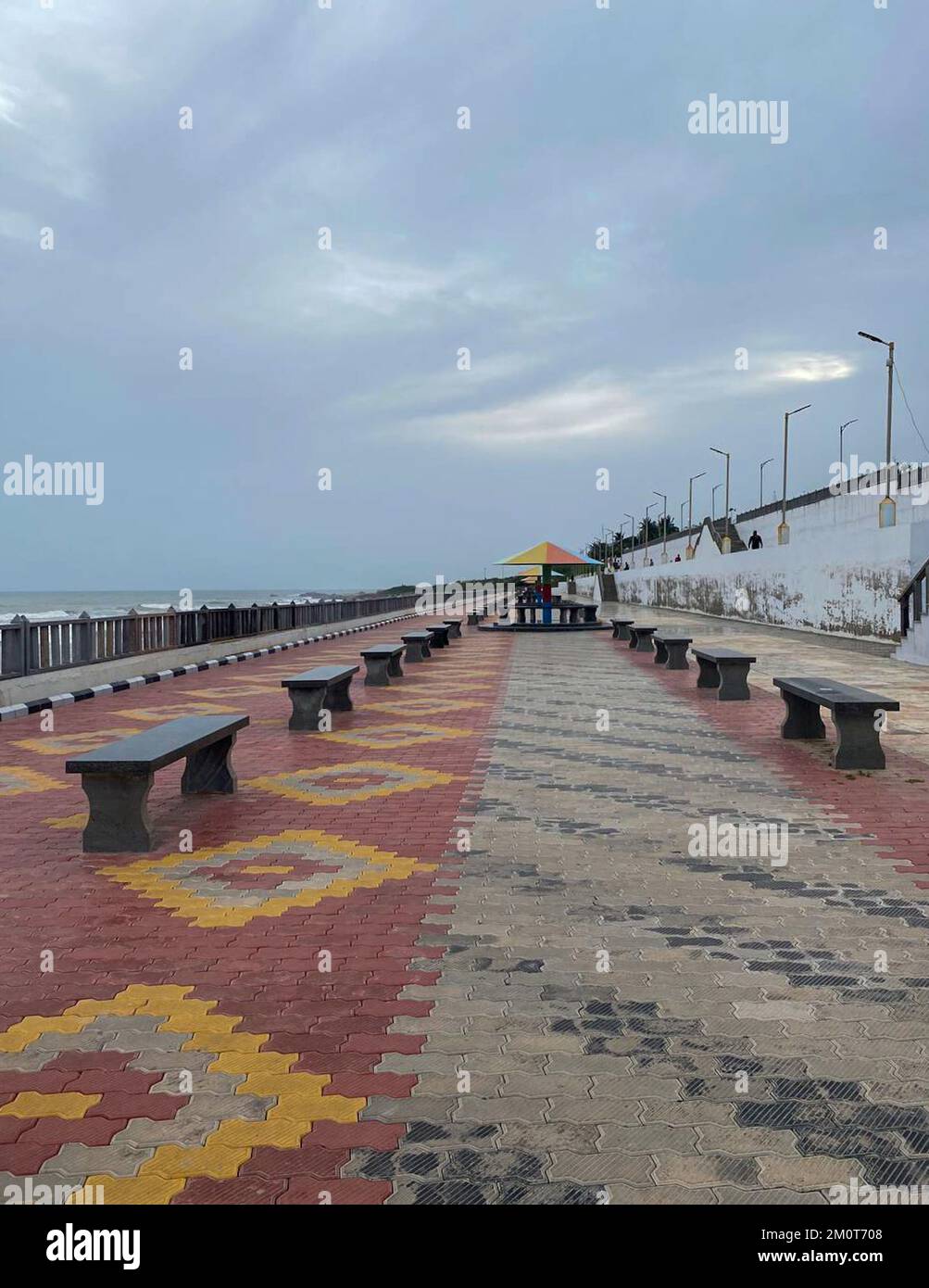 A promenade with benches along the sea Stock Photo - Alamy
