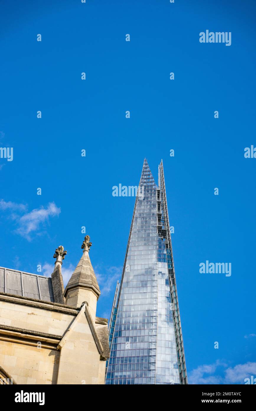 Street view in London of old buildings with the modern Shard building ...