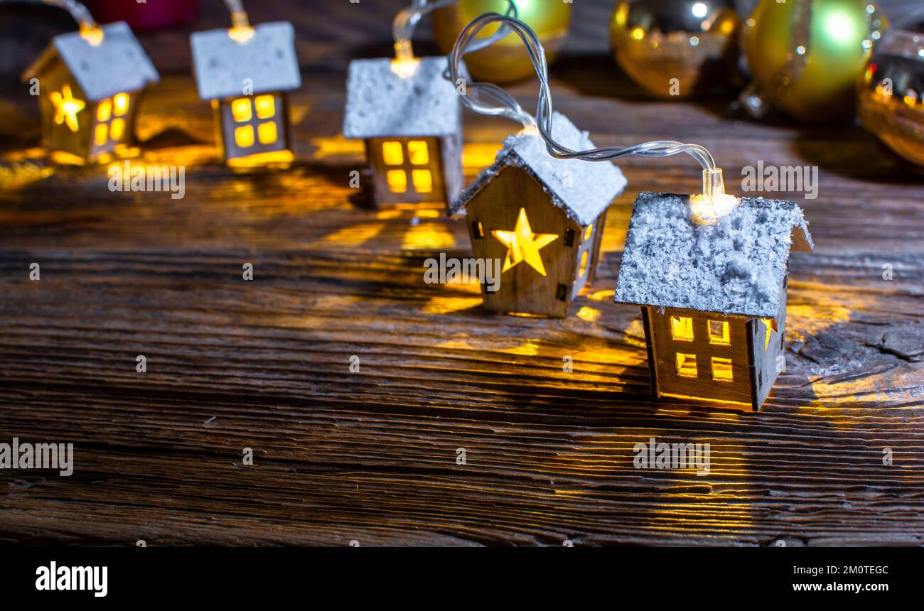 Christmas chain lights on an old wood table, a chain of illuminated ...