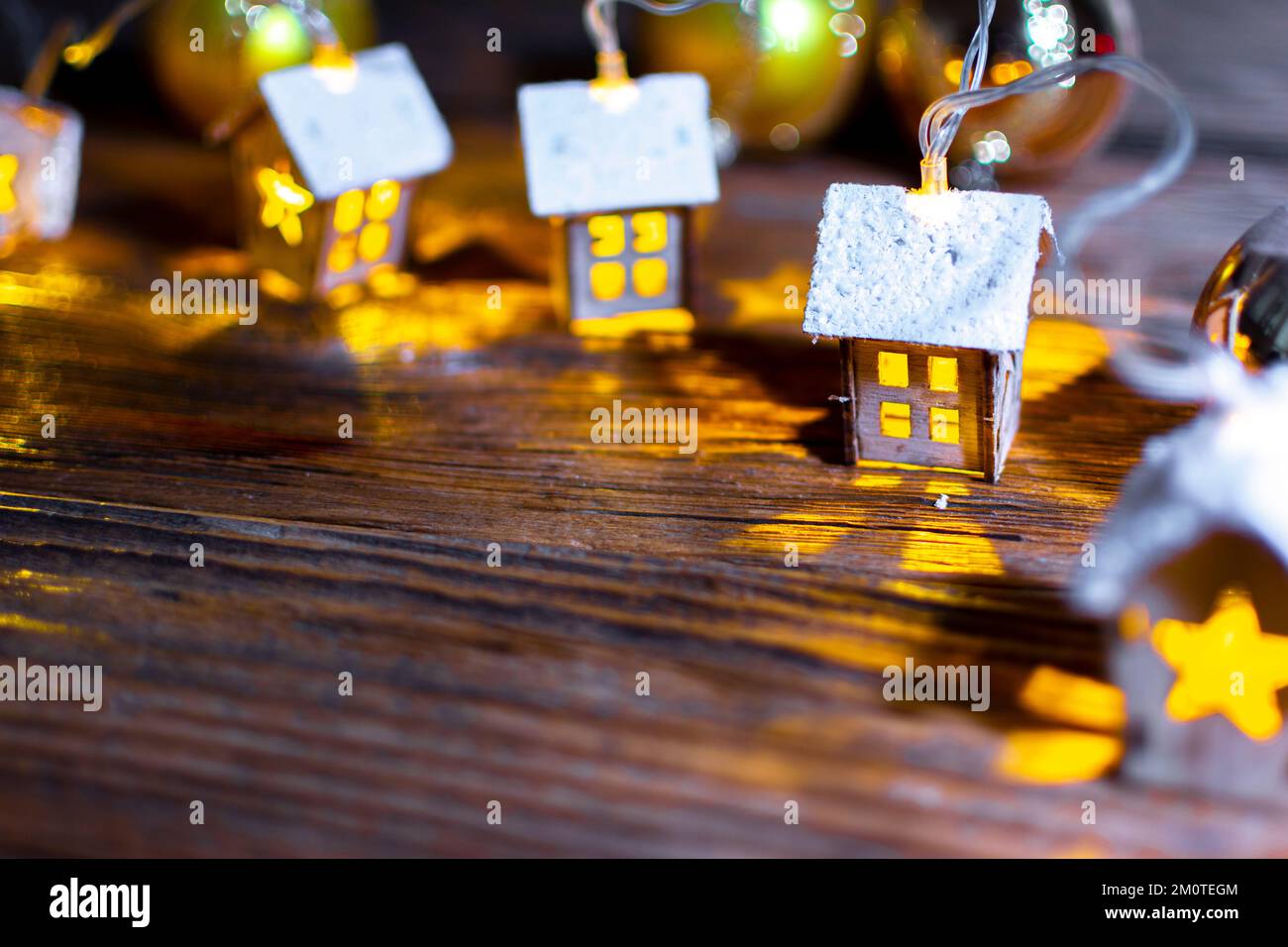 Christmas chain lights on an old wood table, a chain of illuminated ...