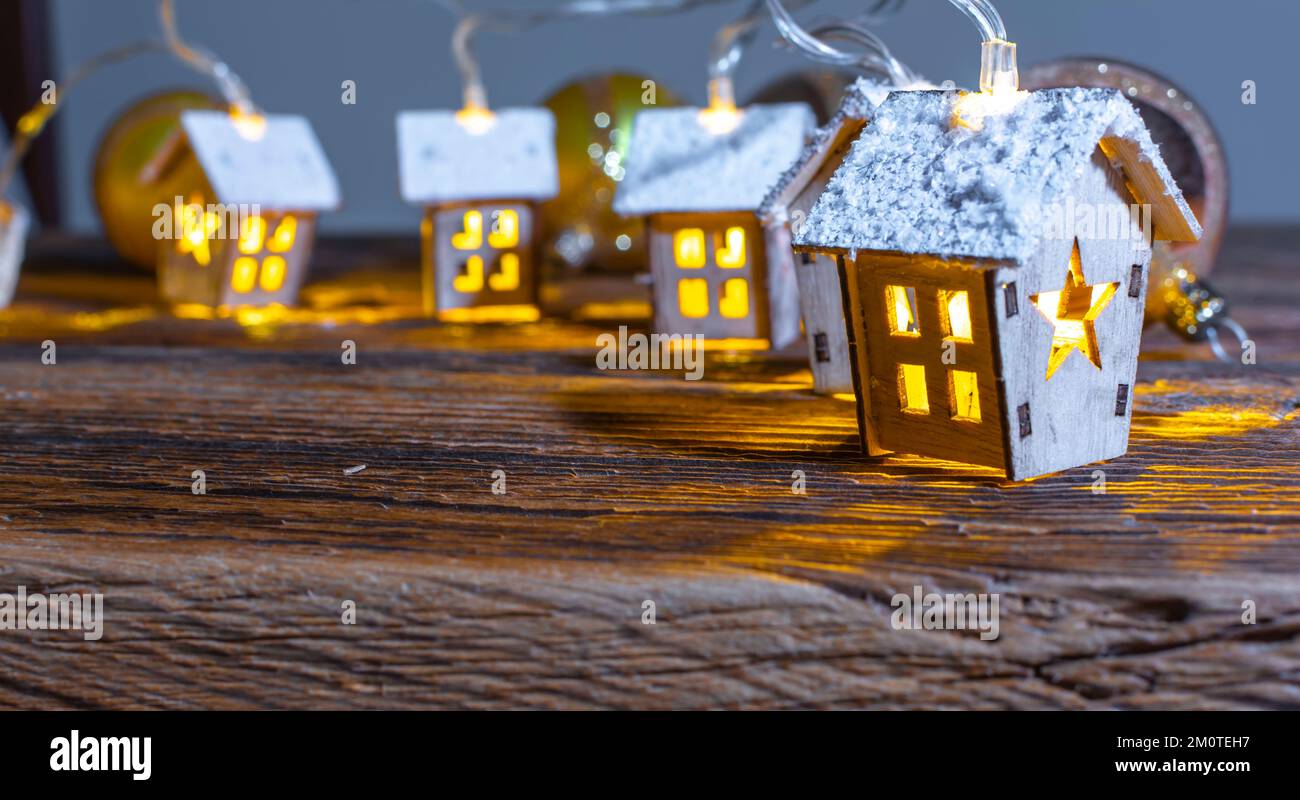 Christmas chain lights on an old wood table, a chain of illuminated ...