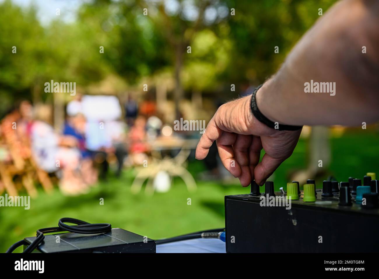 Disc jockey, mixing music on the digital controller table of a sound ...