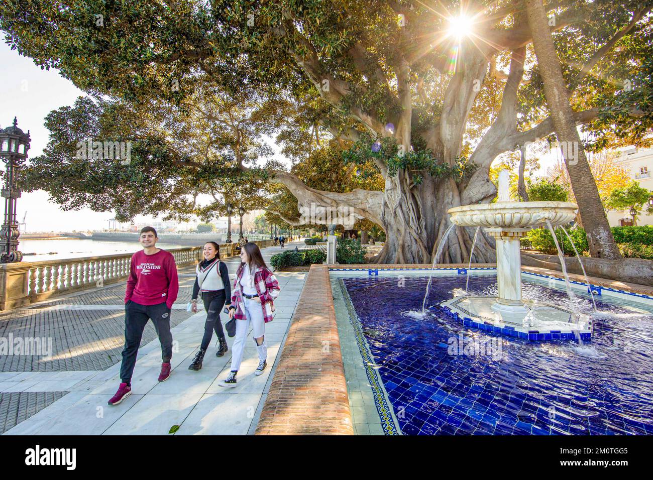 Spain, Andalusia, Cadiz, Alameda Apodaca, young people passing in front ...