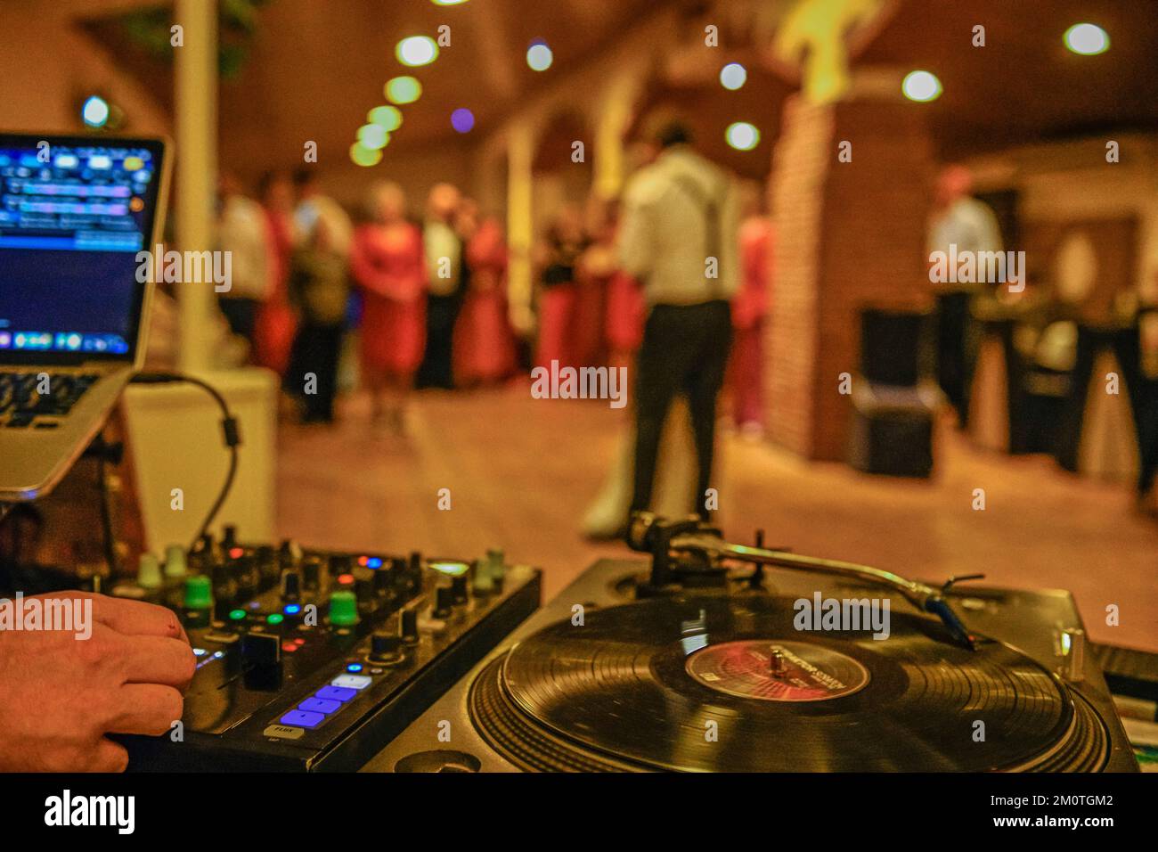 Disc jockey, mixing music on the digital controller table of a sound ...