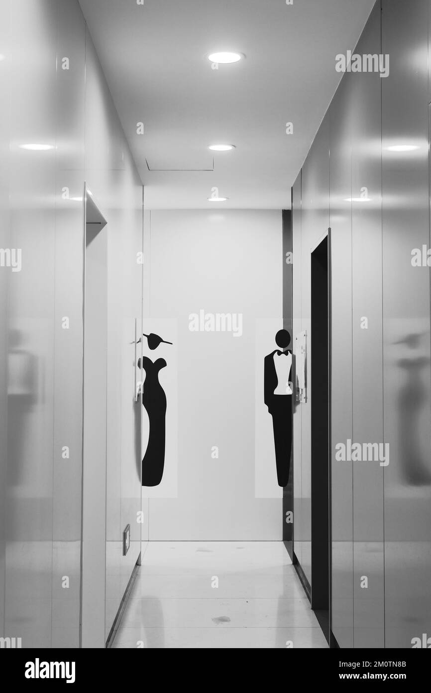 A vertical shot of a corridor with a female sticker on the right and a ...