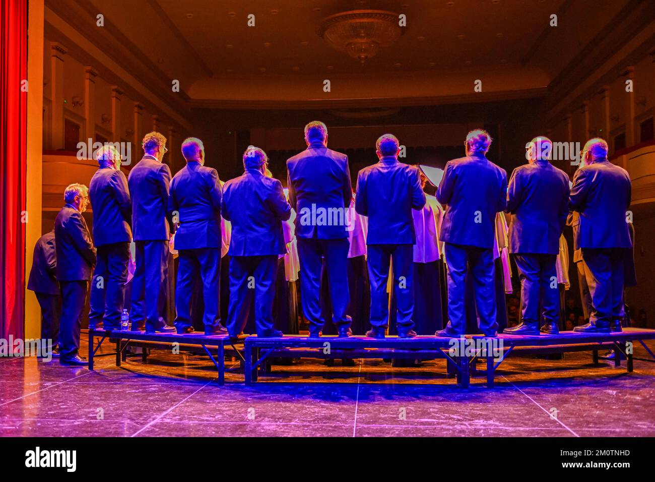 Musical choir singing in a theater. Rear view Stock Photo - Alamy