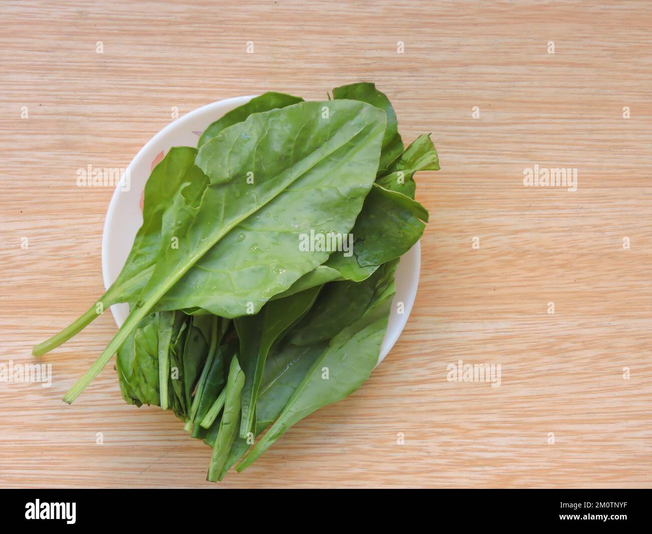 Spinach leaves are a common edible vegetable consumed either fresh, or ...