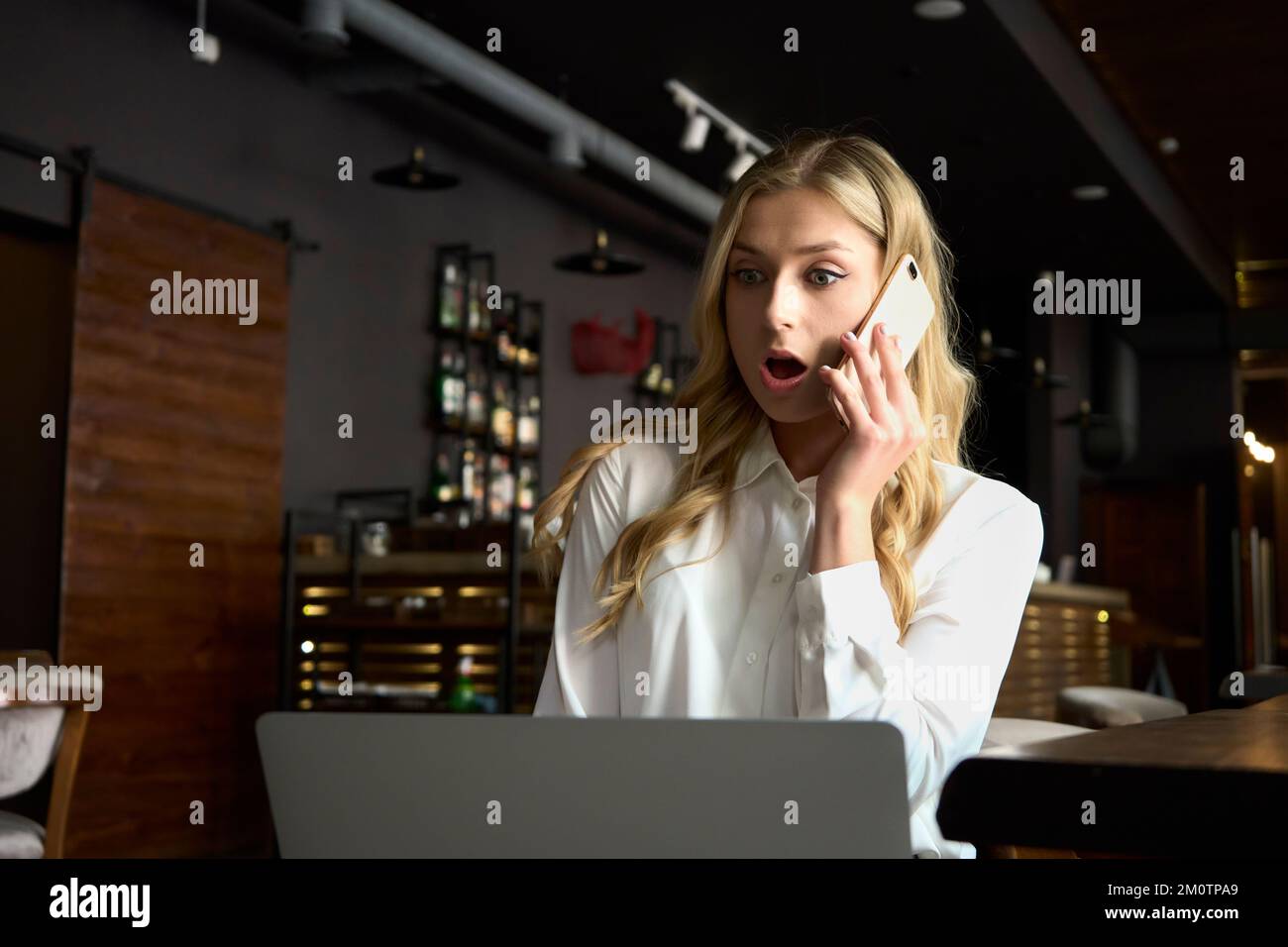 Image of a emotionally blonde woman posing sitting indoors at caffe ...