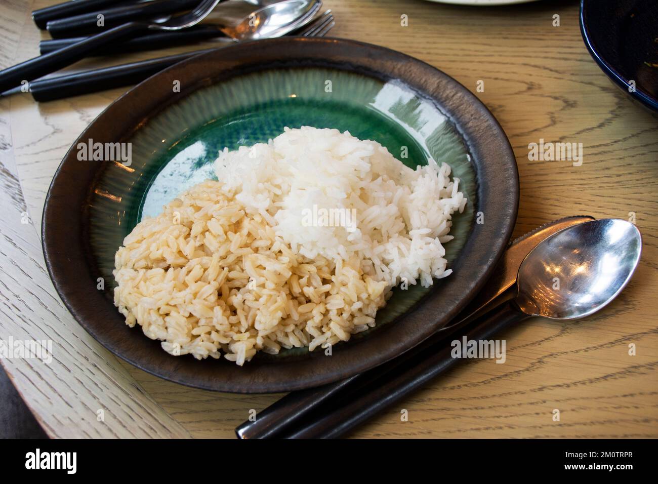 Thai chef cooked brown rice and white rice served in luxury ceramic ...