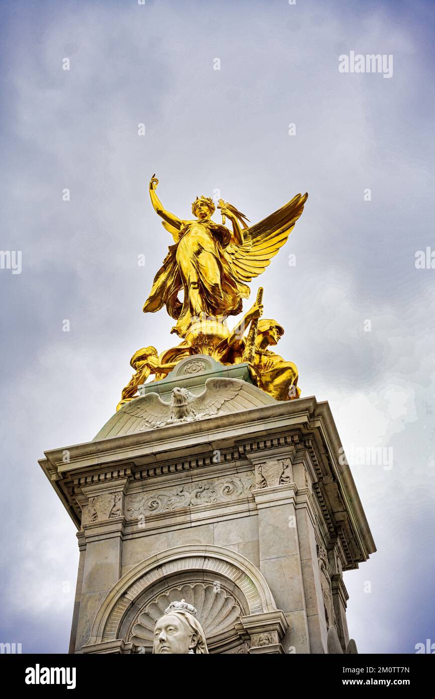 A low angle shot of Queen Victoria Memorial. Golden monument winged ...