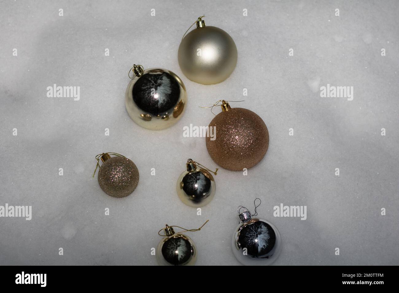 photo of round-shaped Christmas decorations lying on the snow Stock ...