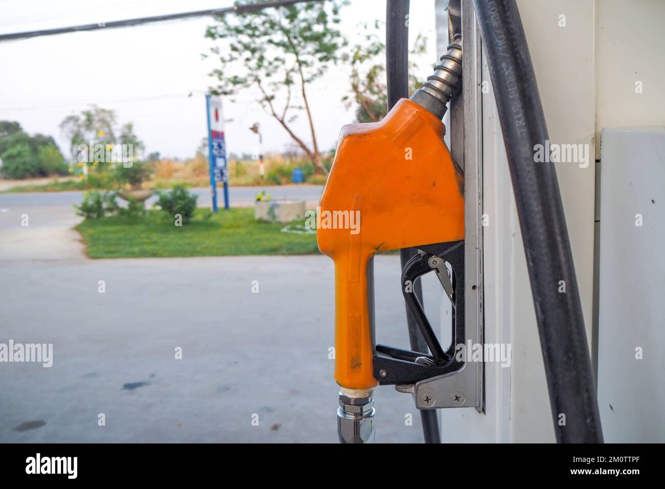 Orange and black oil nozzle Stock Photo - Alamy