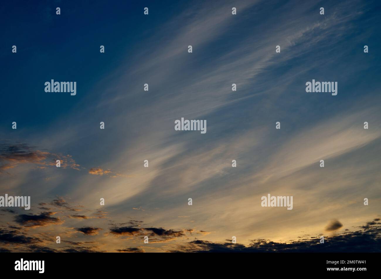 Dramatic yellow and orange sunset sky with clouds and sun rays Stock ...
