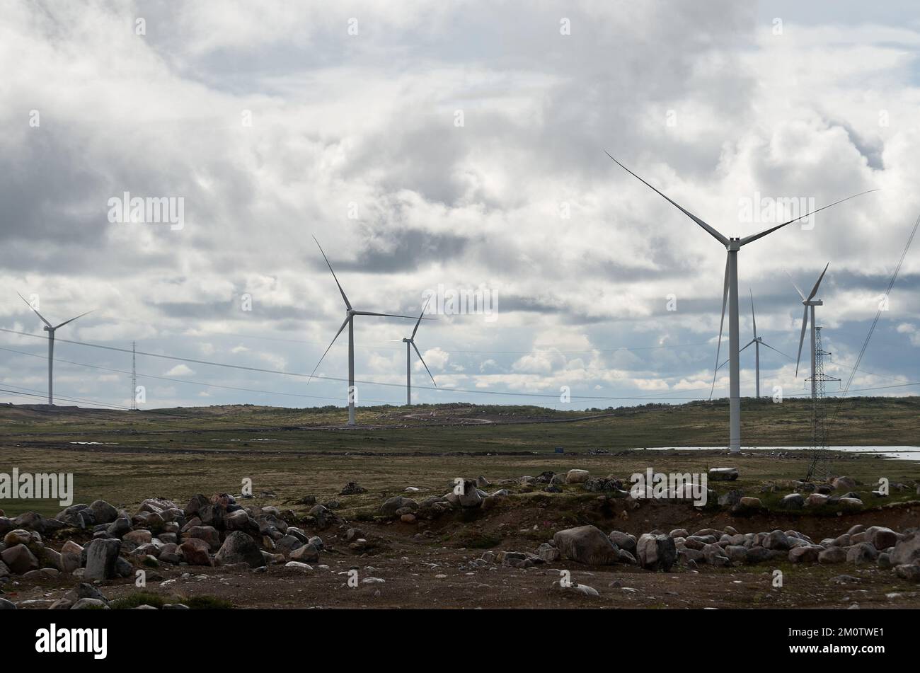 Wind farm in hilly area under cloudy sky Stock Photo - Alamy