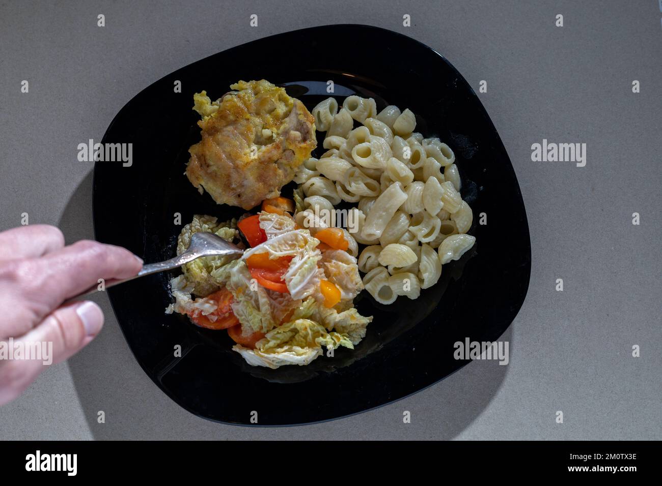 Pasta, salad and cucumber on a plate Stock Photo - Alamy